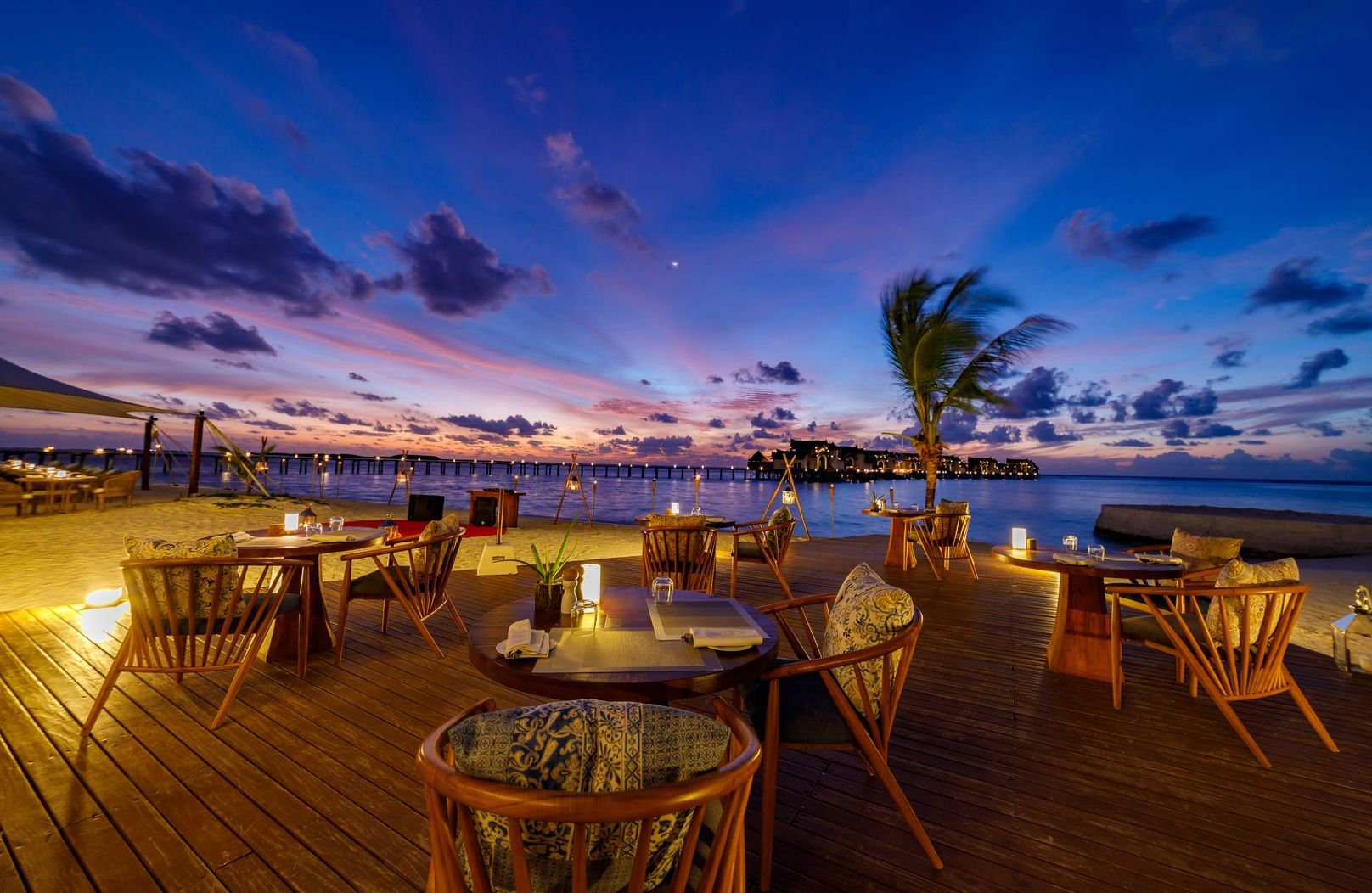 Maldives dining at a charming beachside restaurant with sunset views ...